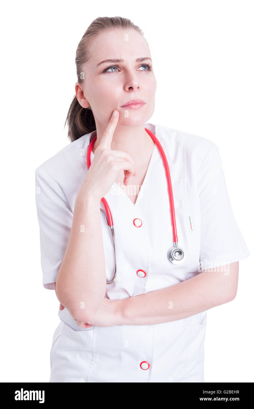 Portrait of pensive woman doctor looking up contemplative and thoughful ...