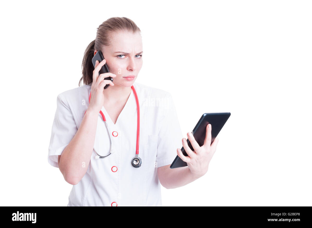 Busy stressed and angry woman doctor using phone and tablet in the same ...