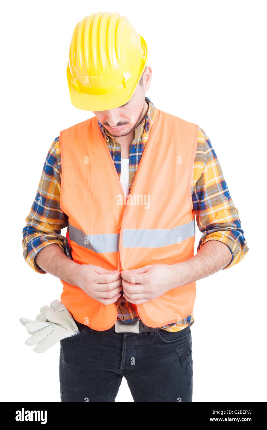 Attractive engineer with gloves in his poket getting dressed with his ...