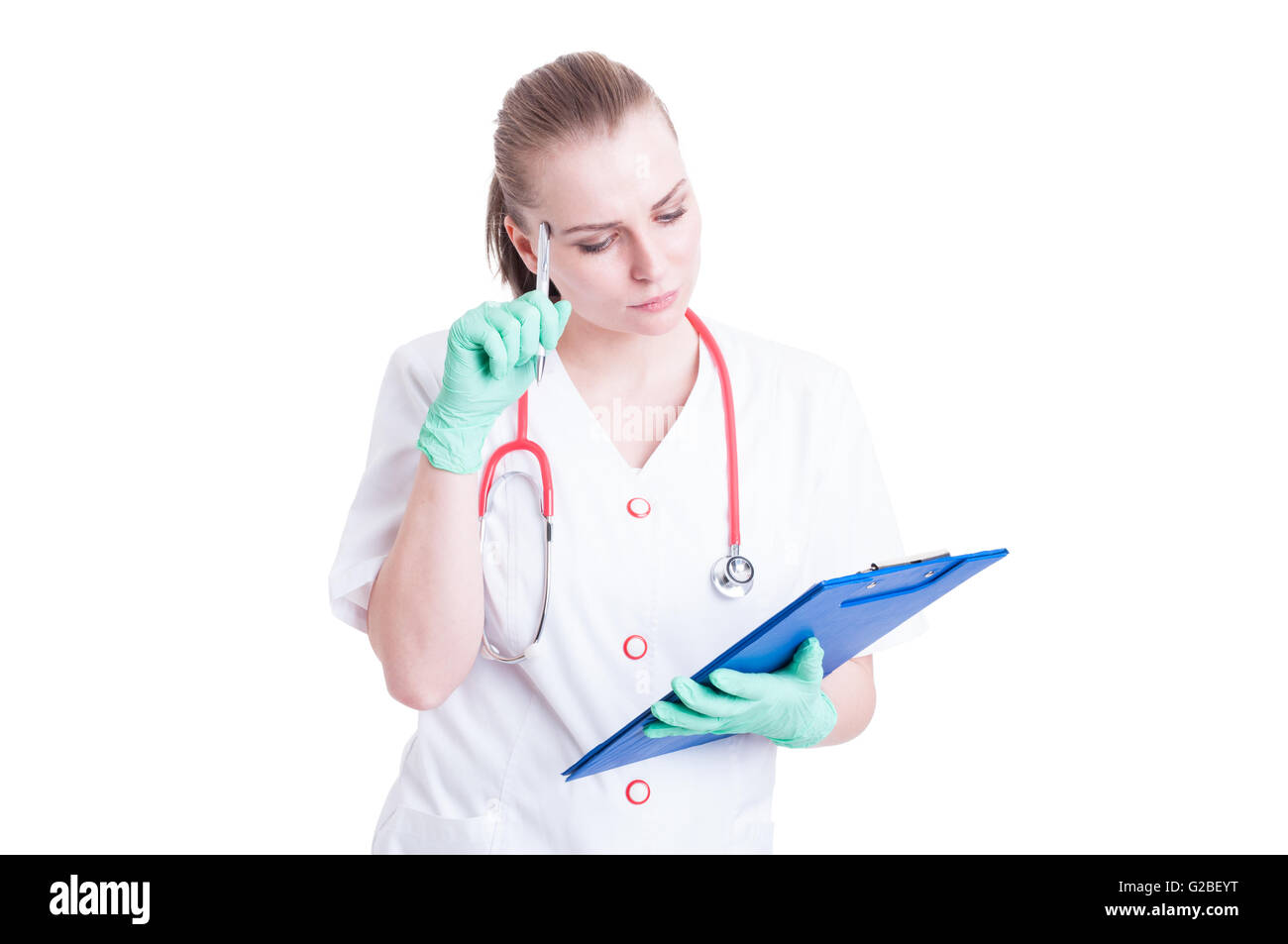 Beautiful pensive woman doctor ponder to a solution with a clipboard on ...