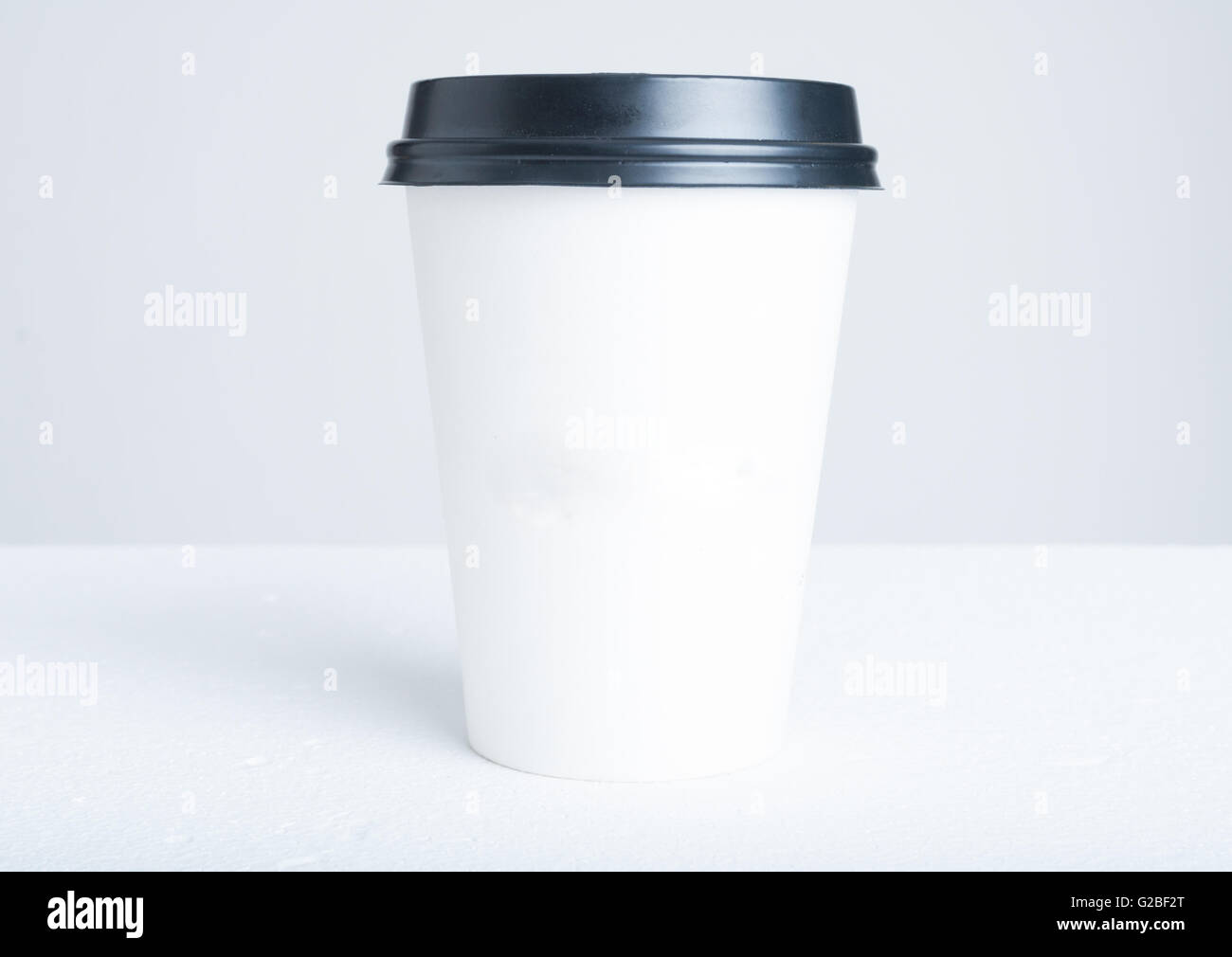 Break time coffee concept with paper cup with plastic top in close-up ...