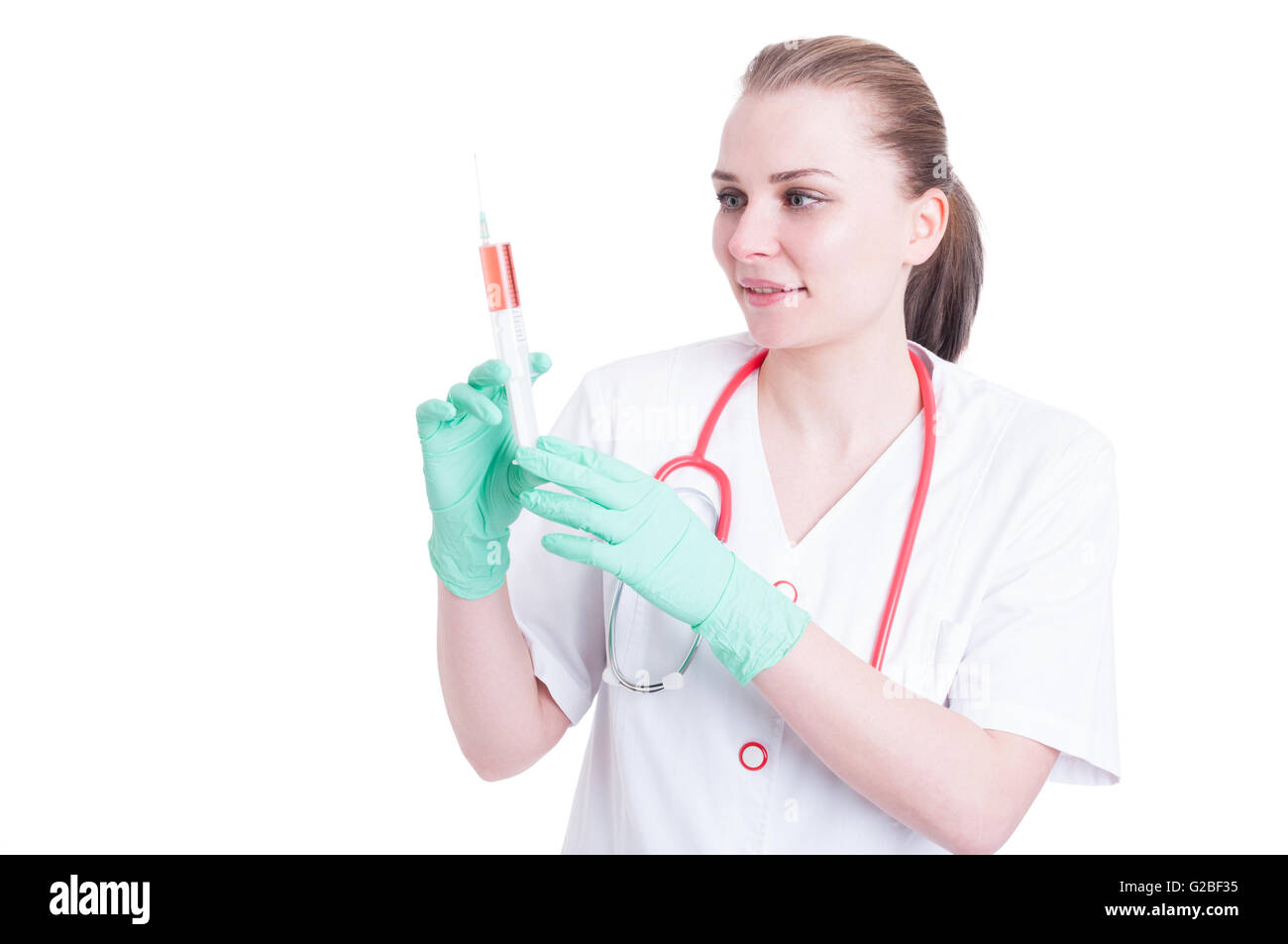 Attractive female doctor preparing and holding a syringe with sharp ...