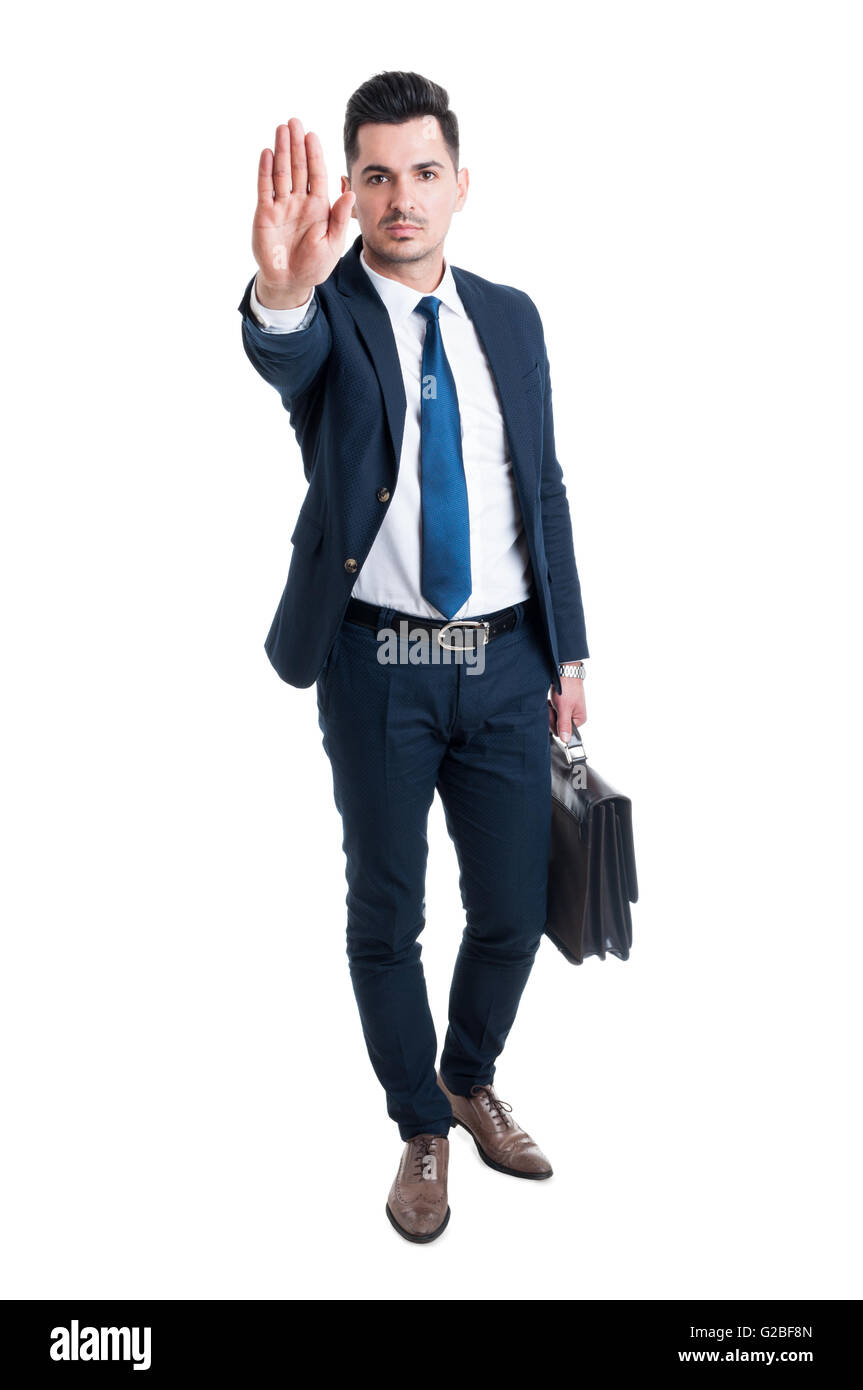 Handsome sales man showing stop gesture standing and holding a ...