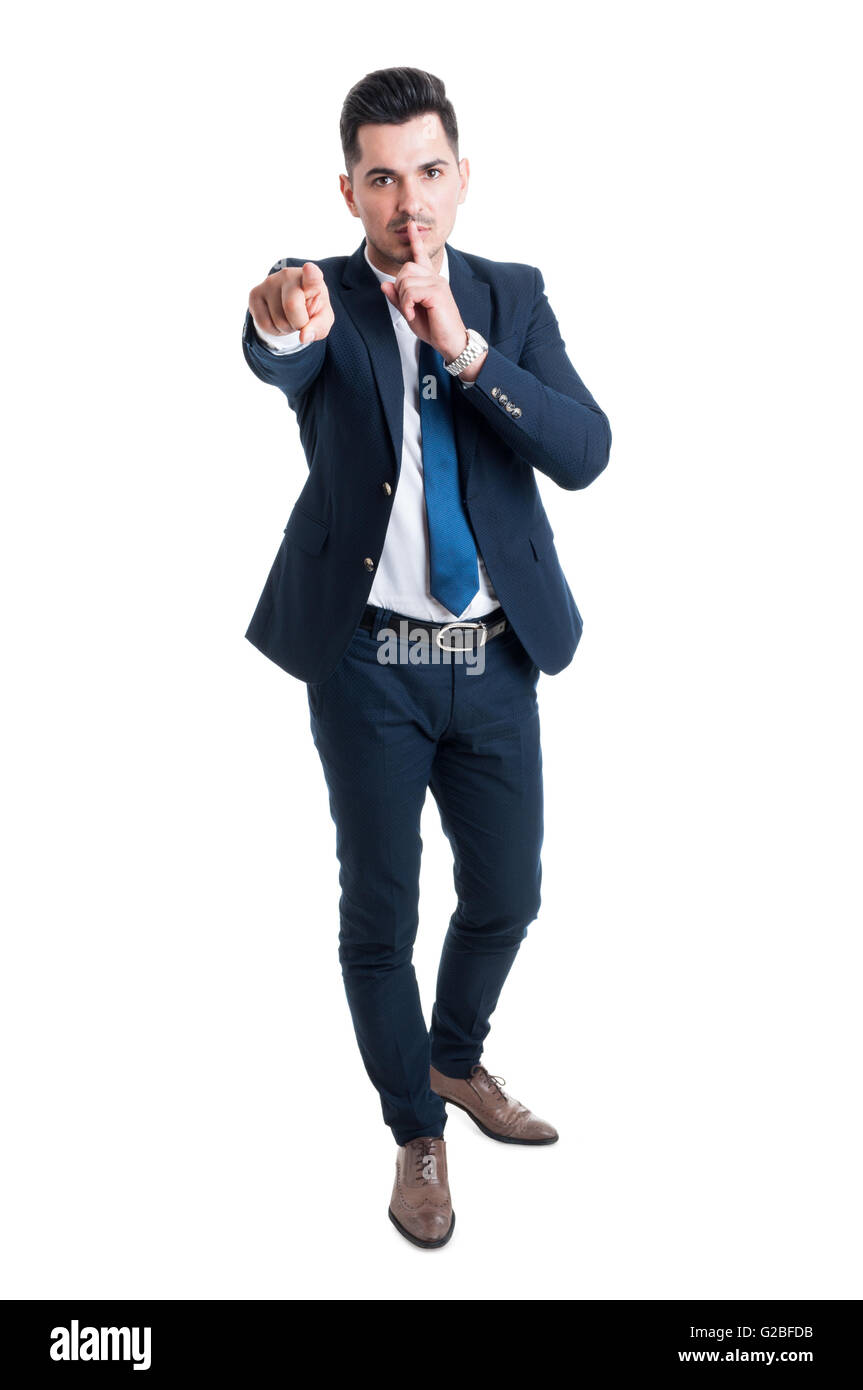 Businessman making keep a secret gesture standing isolated on white ...