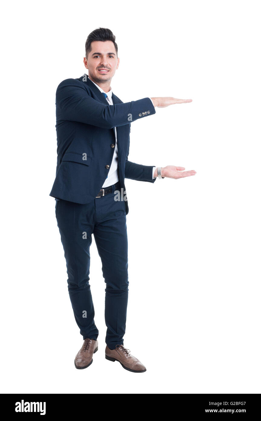 Smiling salesman holding copy space with hands isolated on white ...