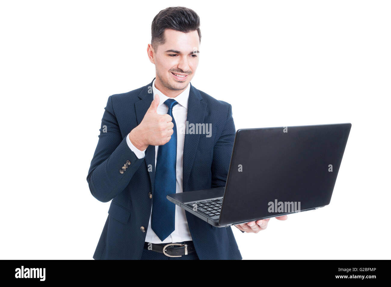 Joyful young salesman holding laptop and thumb up acting confident on ...