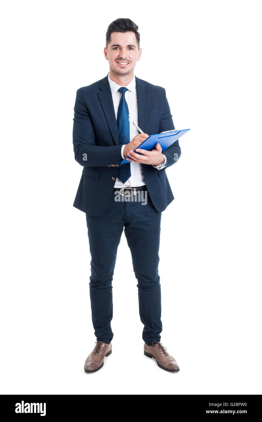 Full body of smiling businessman holding blue clipboard and writing ...