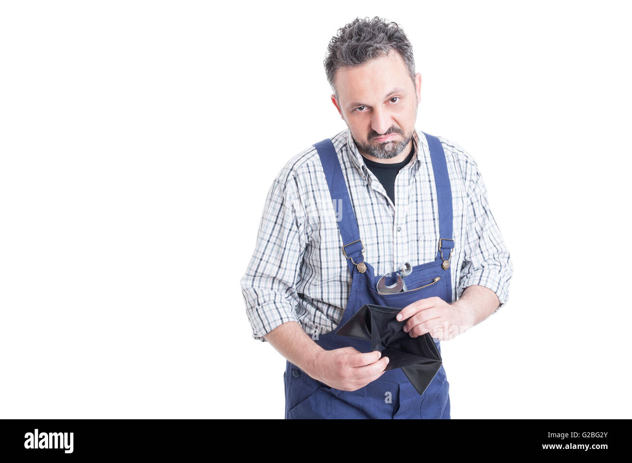 Portrait of unhappy mechanic with wrench holding empty open wallet with ...