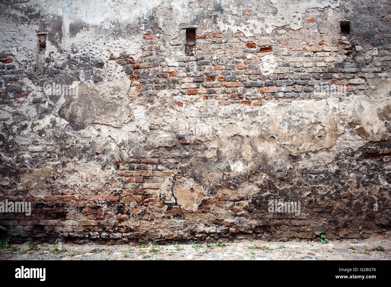 Old weathered wall of bricks and a ground Stock Photo - Alamy