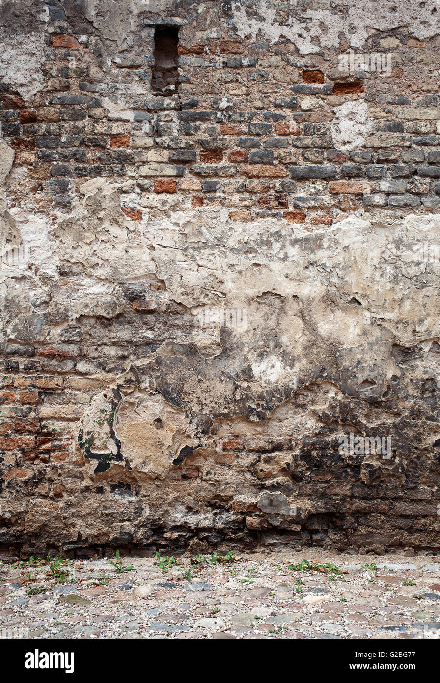 Old weathered wall of bricks and a ground Stock Photo - Alamy