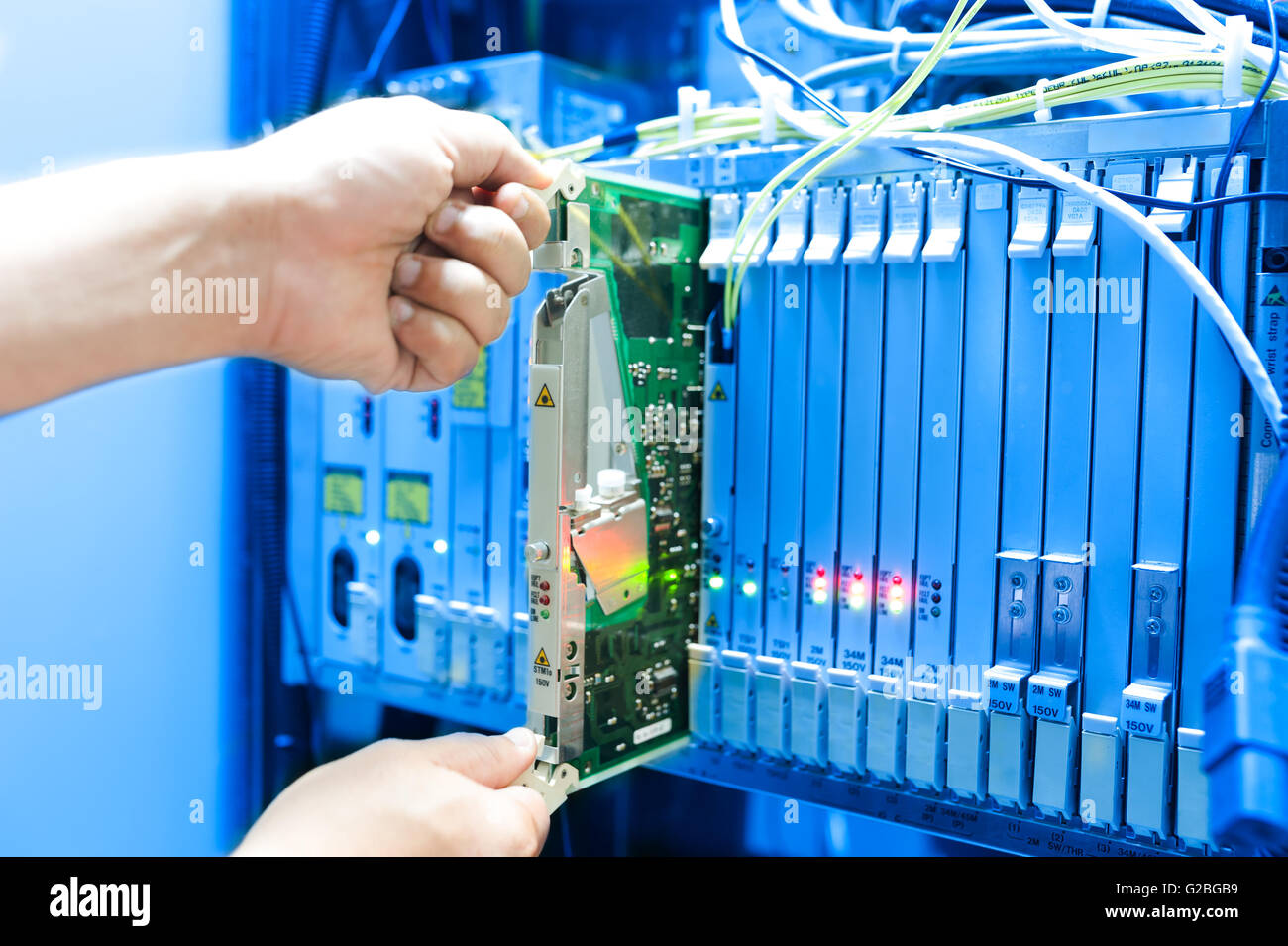 People fix core switch in network room Stock Photo - Alamy