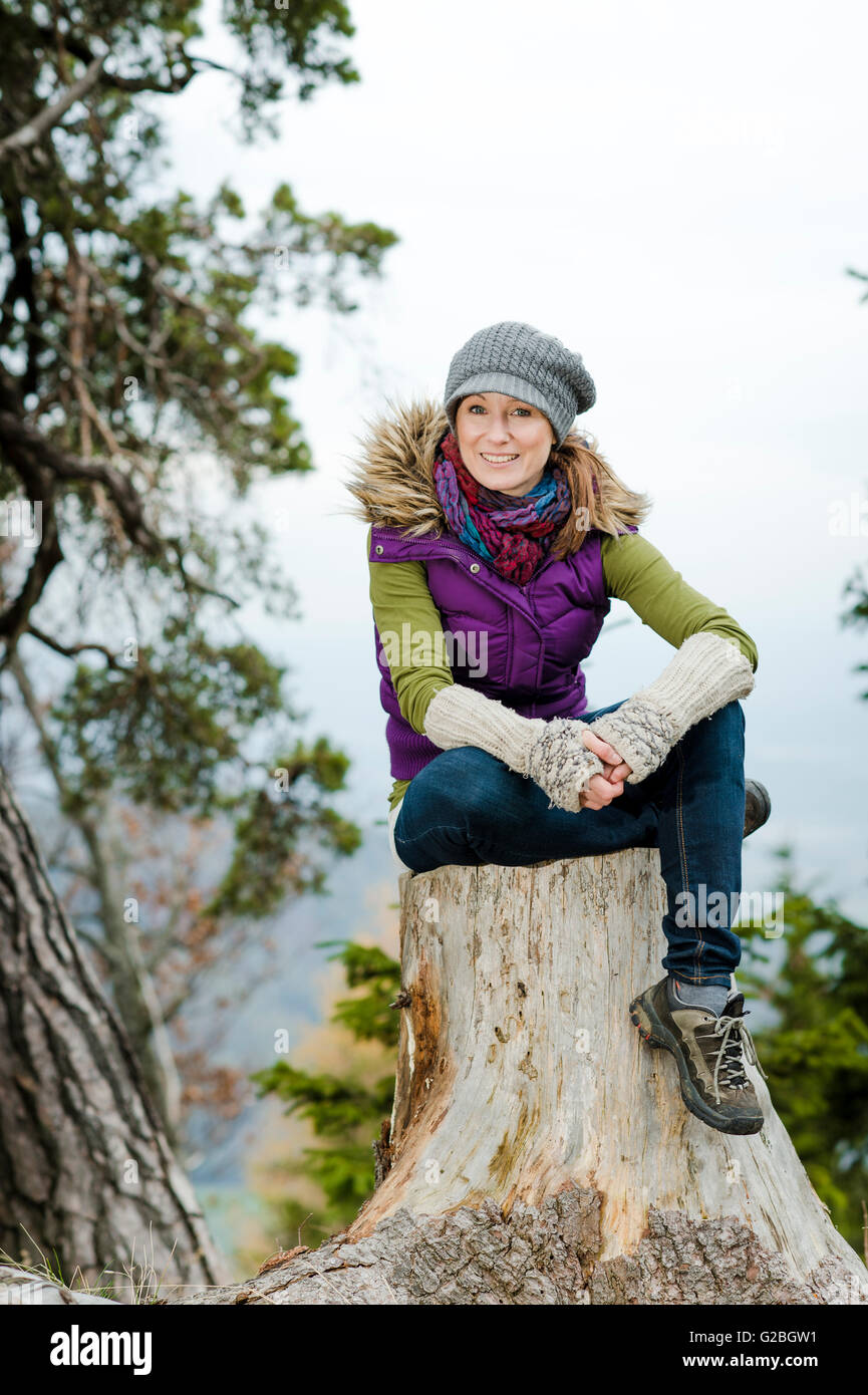 Woman sitting on a stump hi-res stock photography and images - Alamy