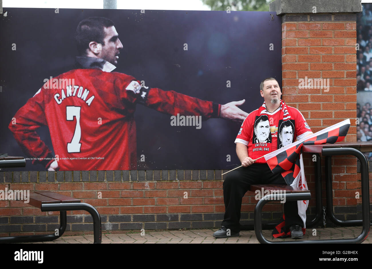 Manchester United fan John Bartrum sits next to a poster of former ...