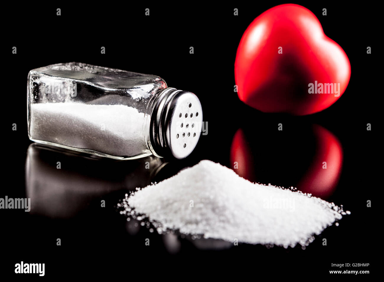 Heart and salt isolated on black background with reflection Stock Photo ...