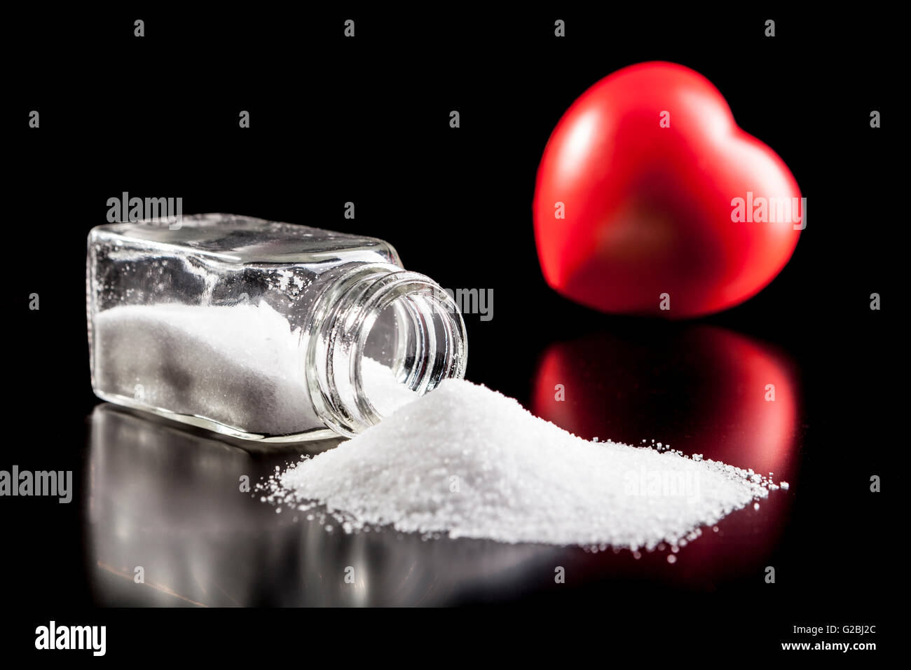 Heart and salt isolated on black background with reflection Stock Photo ...