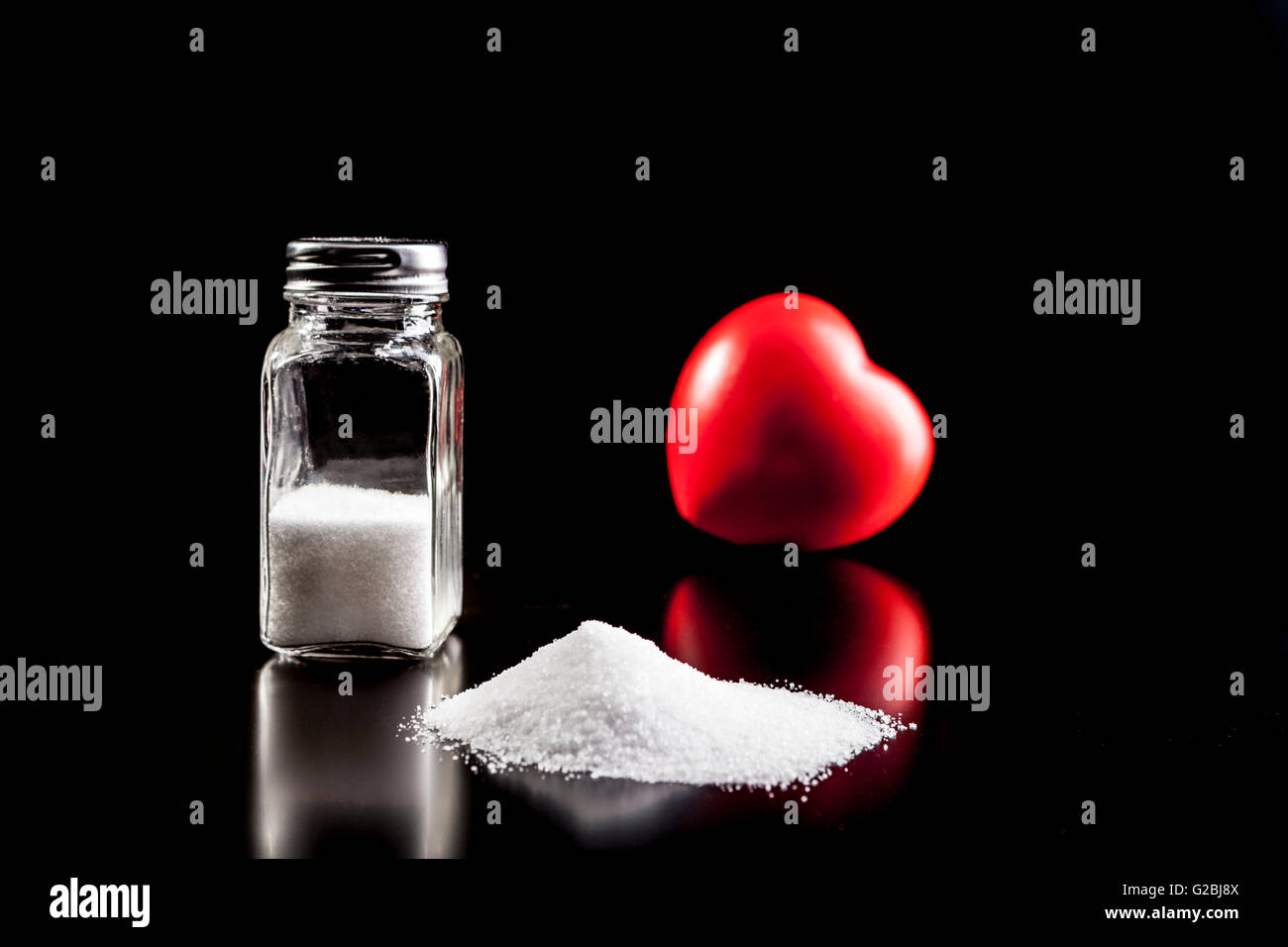 Salt and heart isolated on black background with reflection Stock Photo ...