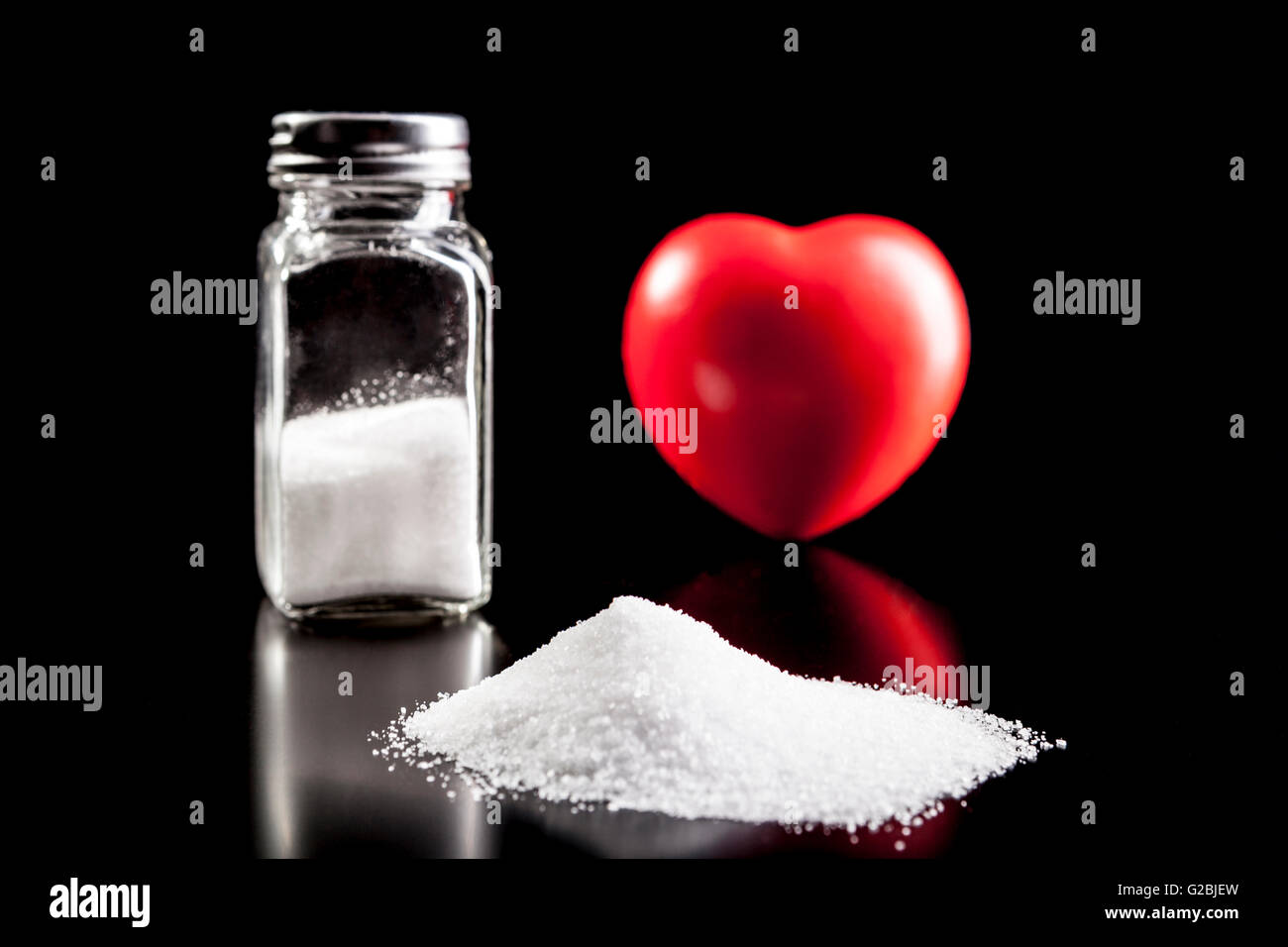 Salt and heart isolated on black background with reflection Stock Photo ...