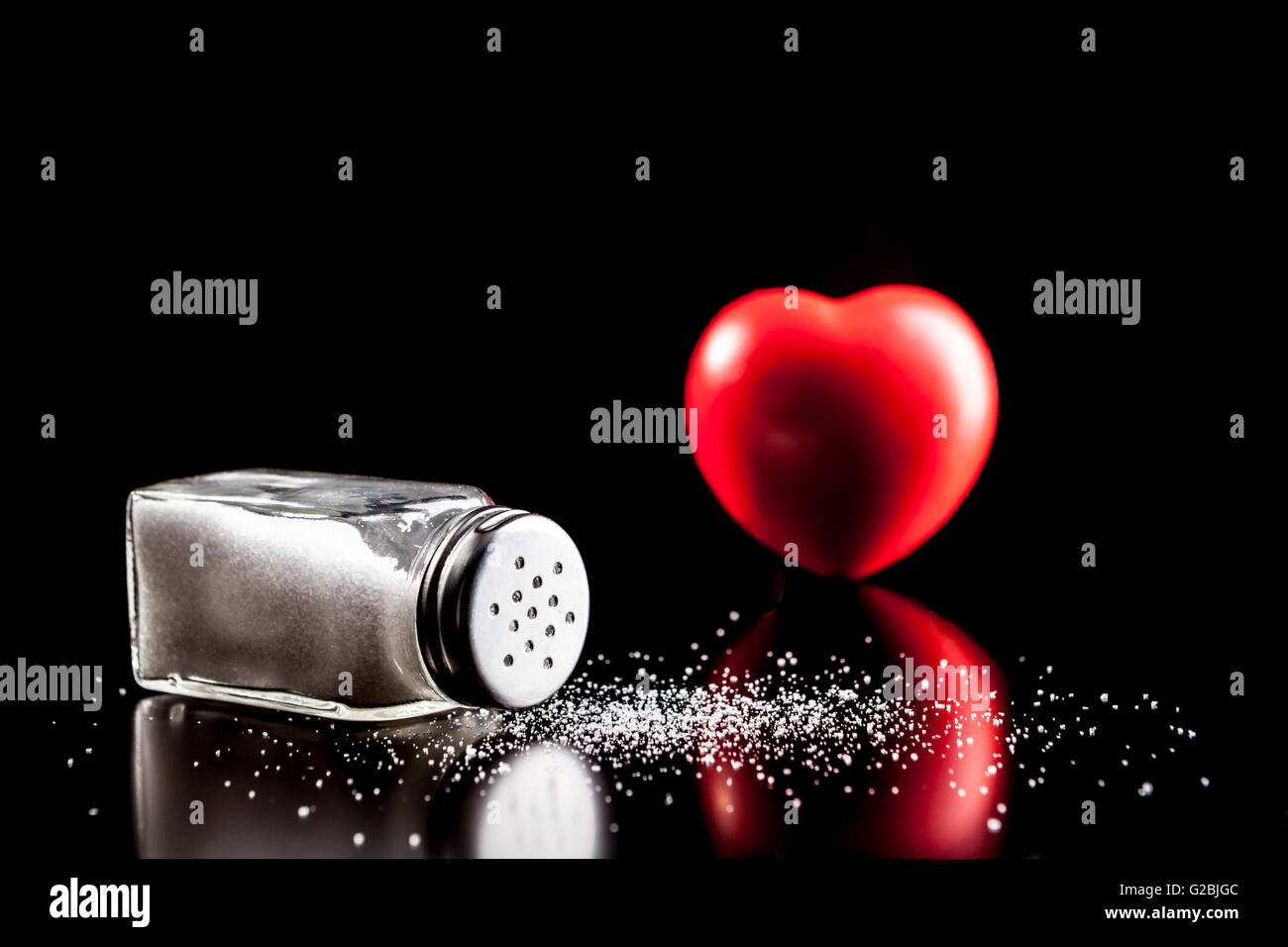 Salt and heart isolated on black background with reflection Stock Photo ...