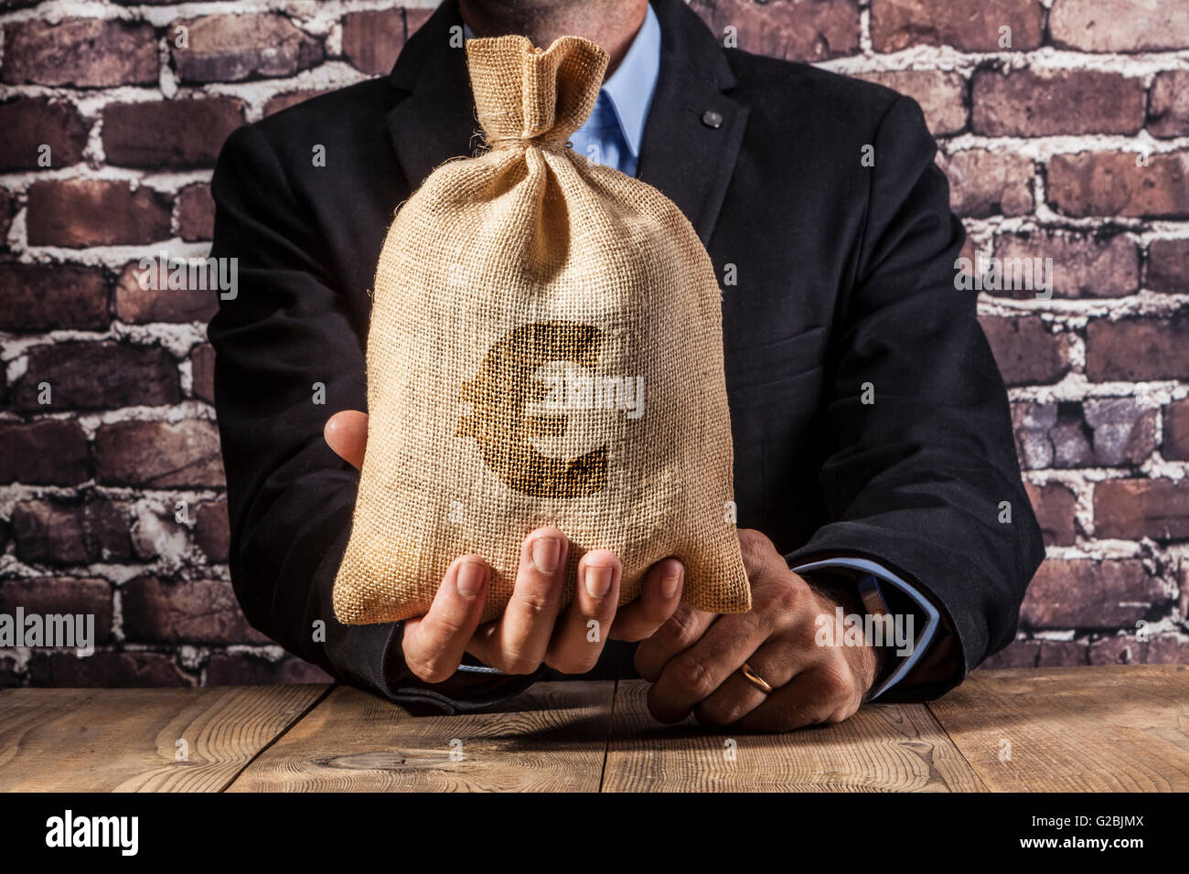Man holding a big sack of money Stock Photo - Alamy