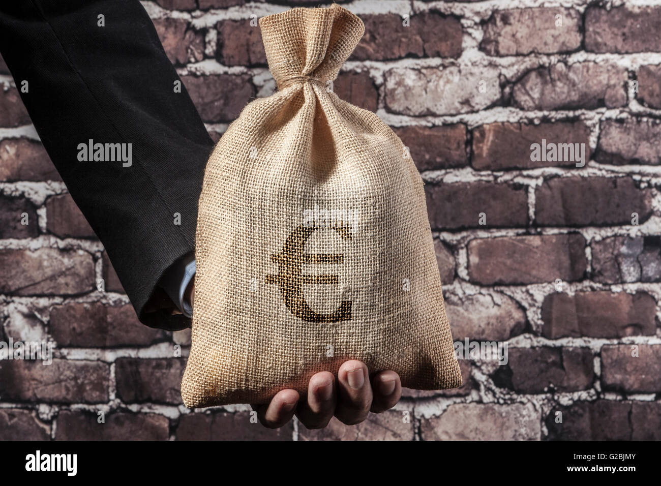 Man holding a big sack of money Stock Photo - Alamy