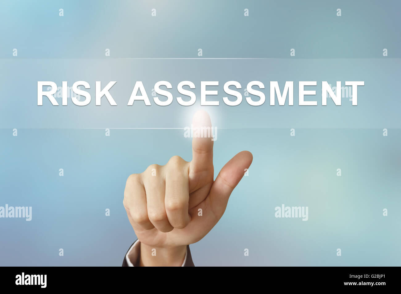 business hand pushing risk assessment button on blurred background ...