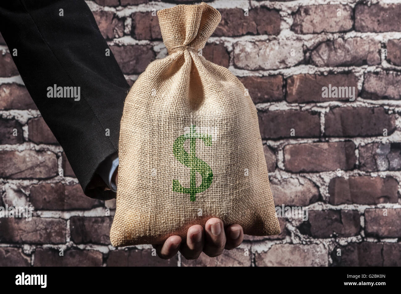 Man holding a big sack of money Stock Photo - Alamy