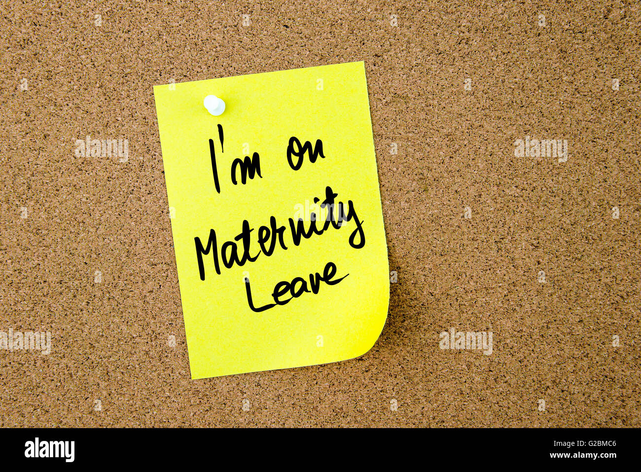 I Am On Maternity Leave written on yellow paper note pinned on cork ...