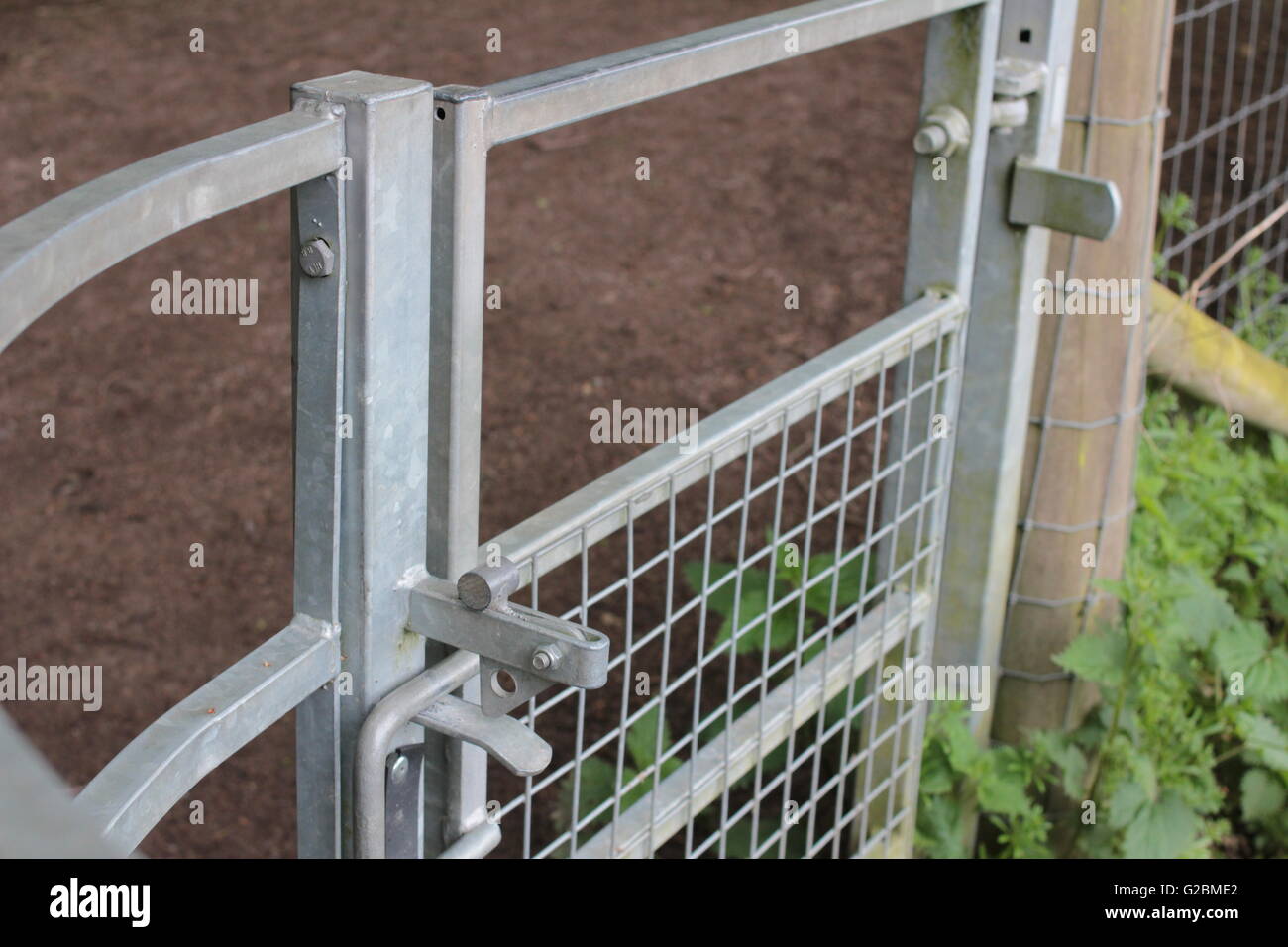 Country metal gate on walking track Stock Photo - Alamy