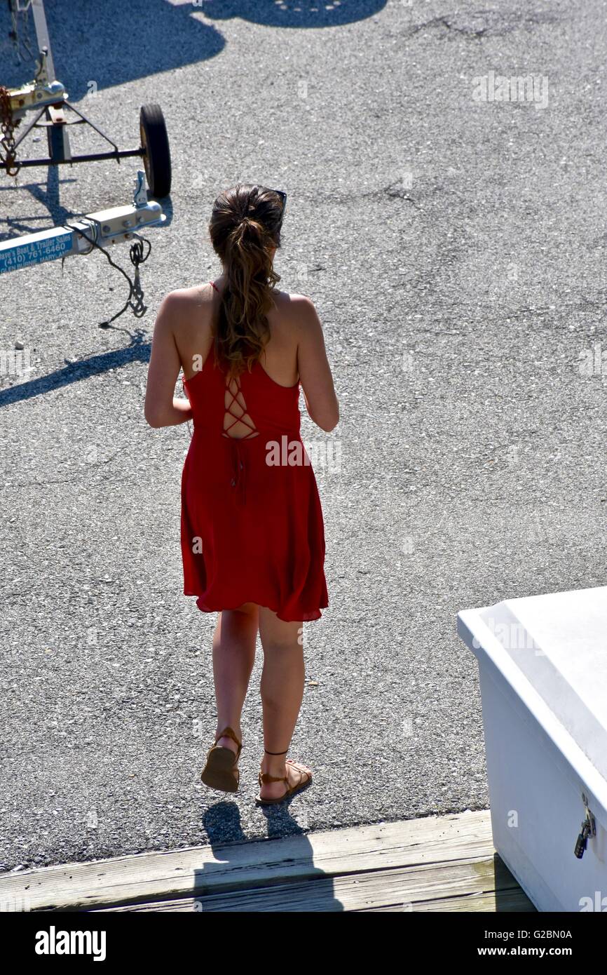 Woman wearing red dress walking hi-res stock photography and images - Alamy