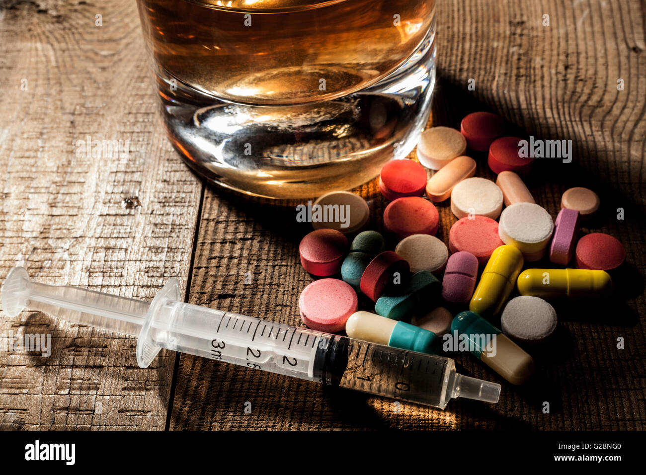 Alcohol and pills on table with shadow Stock Photo - Alamy