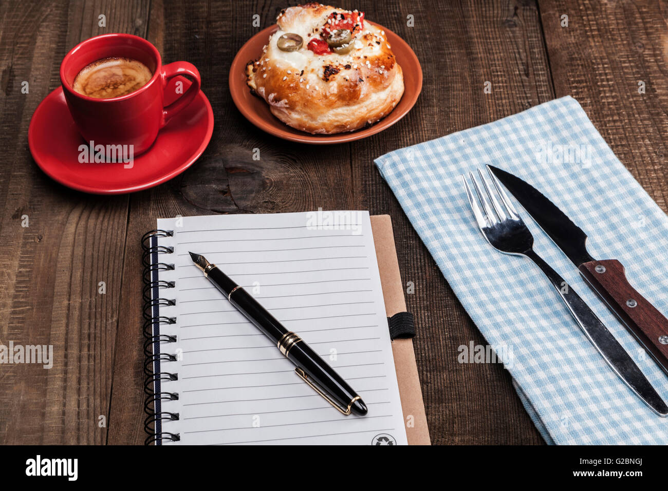 Pen and paper,coffe and some food Stock Photo - Alamy