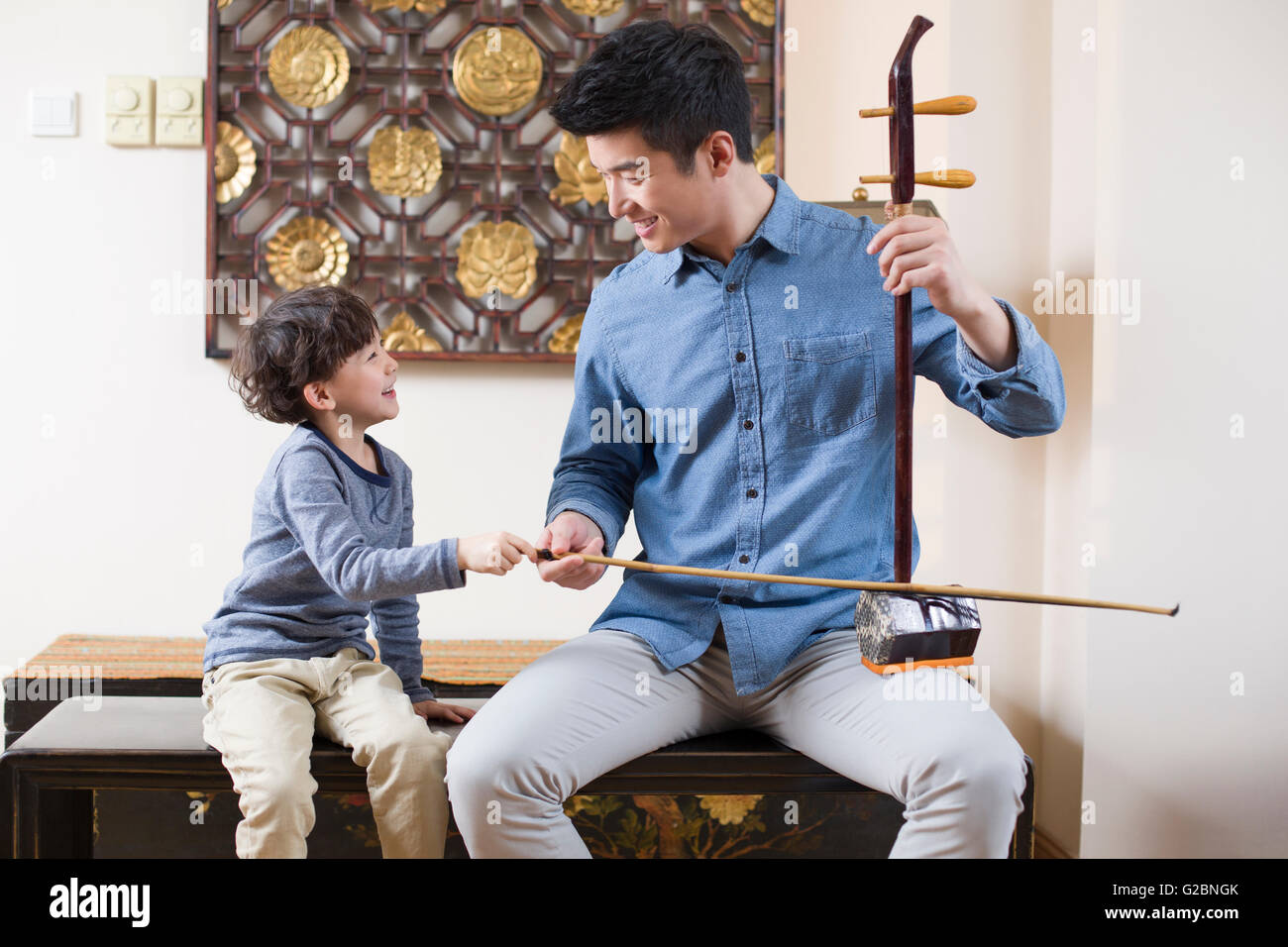 Father teaching traditional musical instrument erhu Stock Photo - Alamy