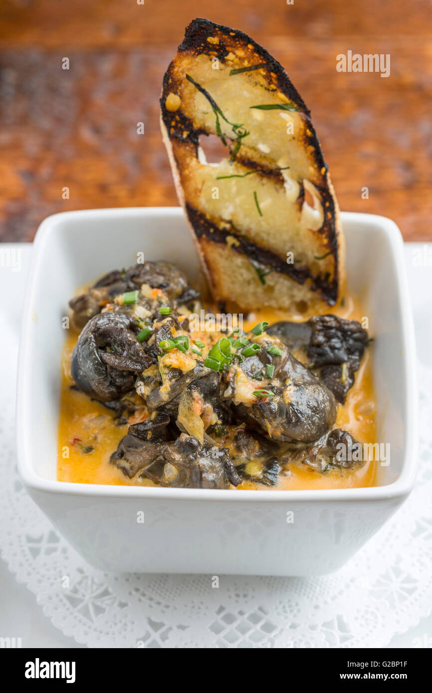 Portuguese Escargot with toast in a small white bowl Stock Photo - Alamy