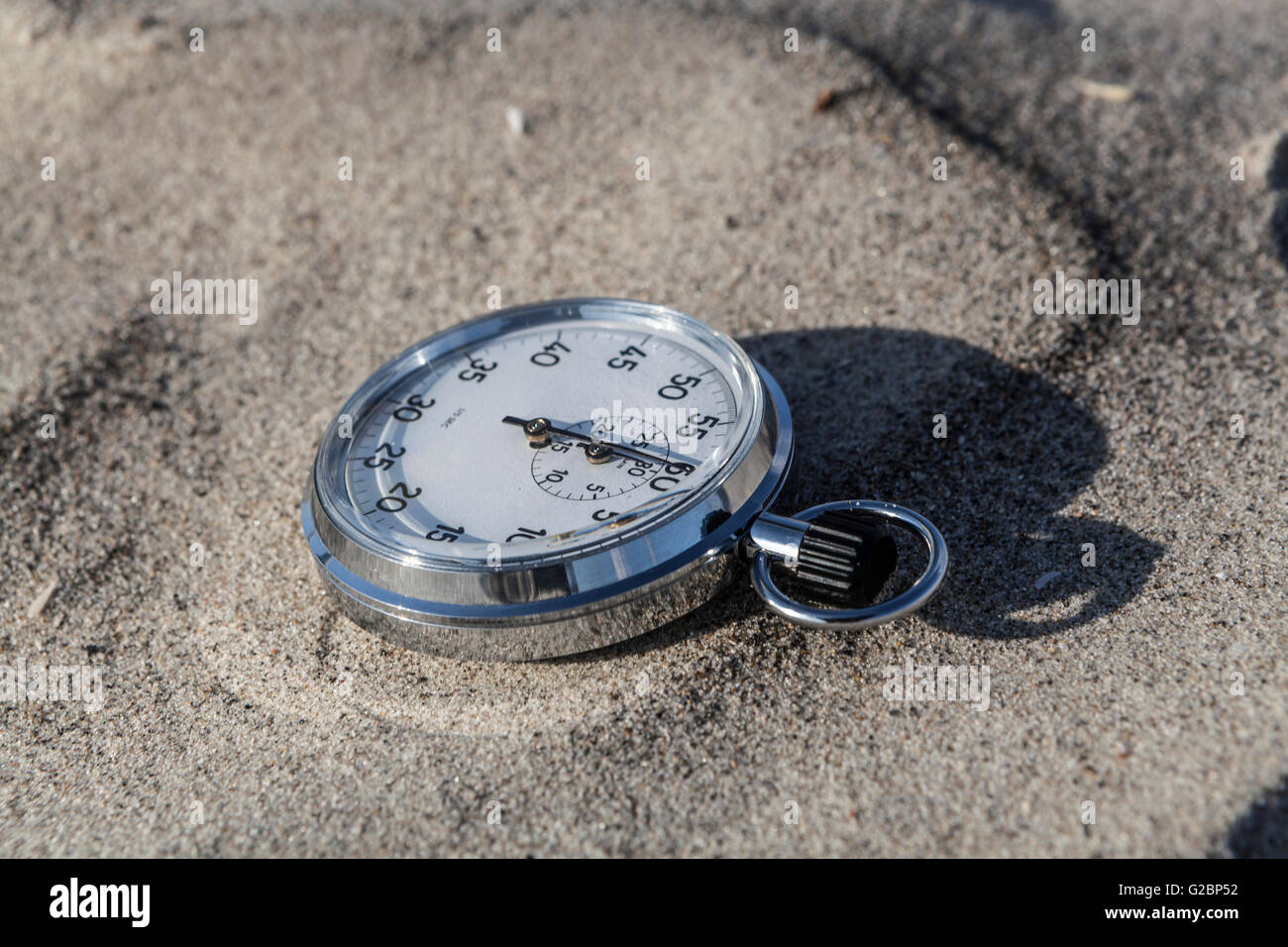 analog Stopwatch on wet sea sand Stock Photo - Alamy