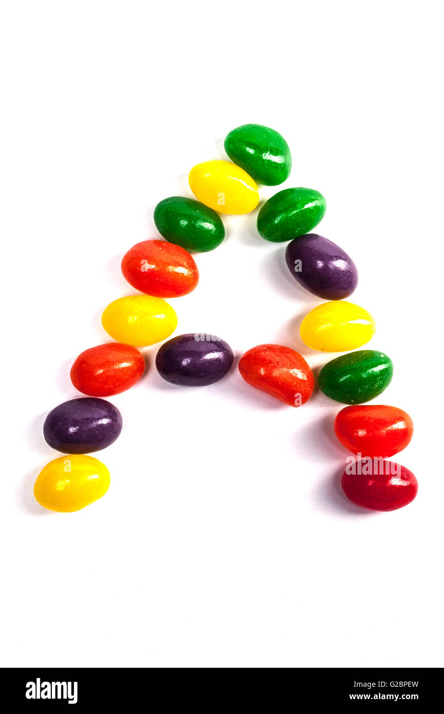 Letter A made from candies isolated on white background with shadow ...