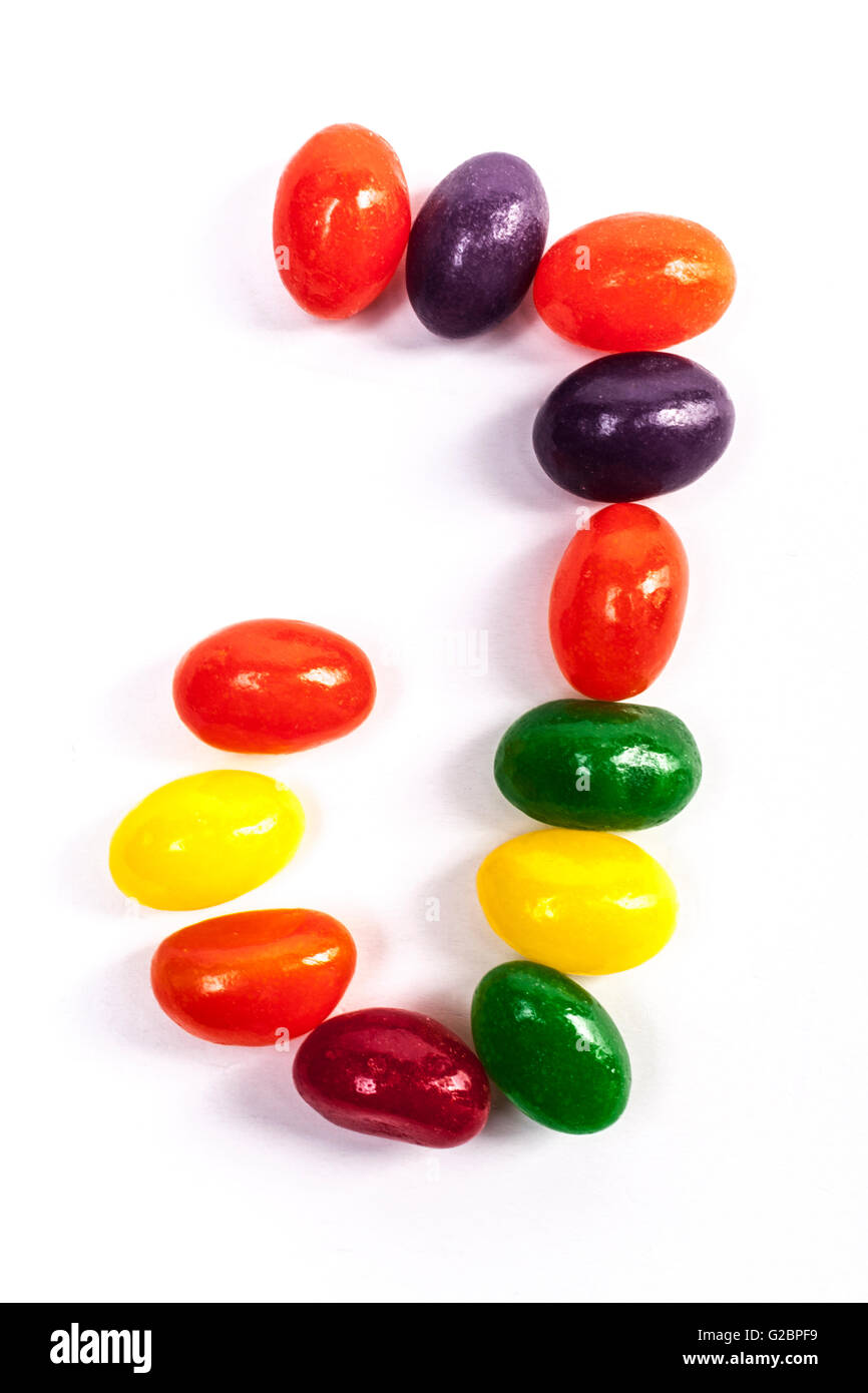 Letter J made from candies isolated on white background with shadow ...