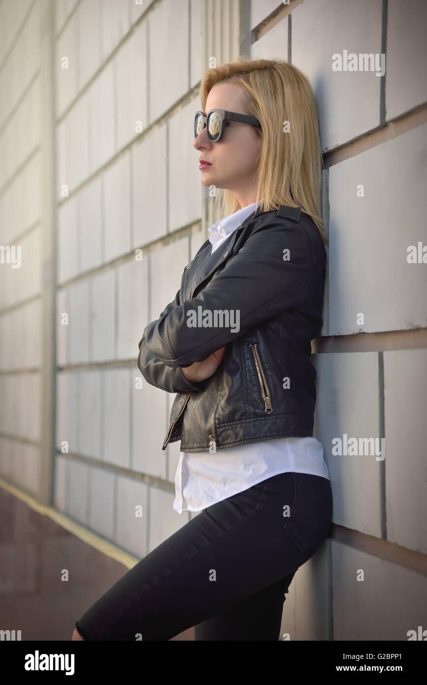 Attractive girl standing near wall hi-res stock photography and images ...