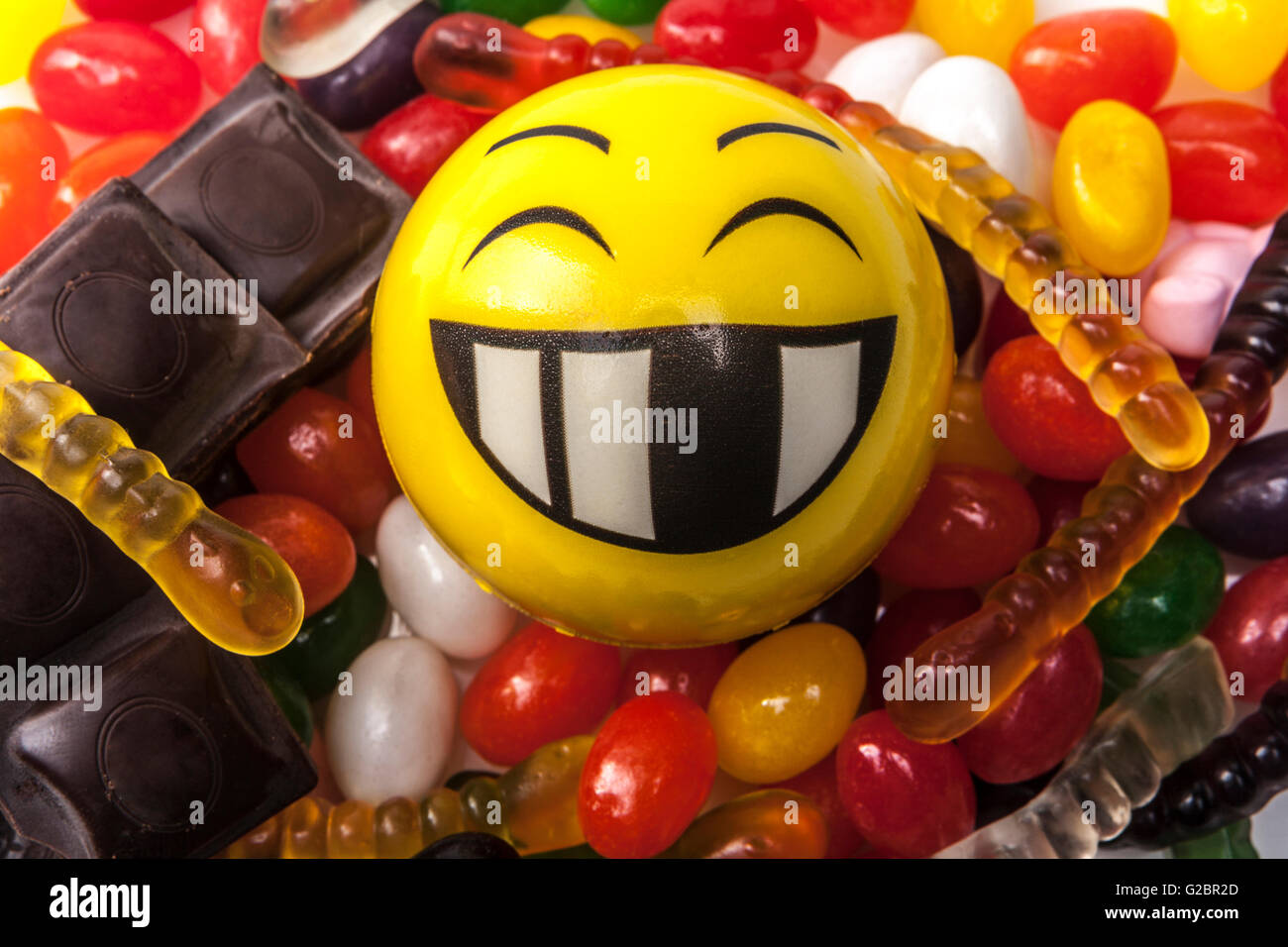 Happy emoticon and a lot of sweets Stock Photo - Alamy