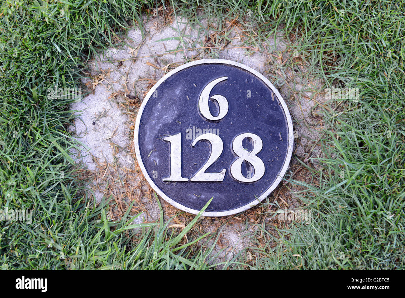 yardage marker on hole in golf course fairway Stock Photo - Alamy