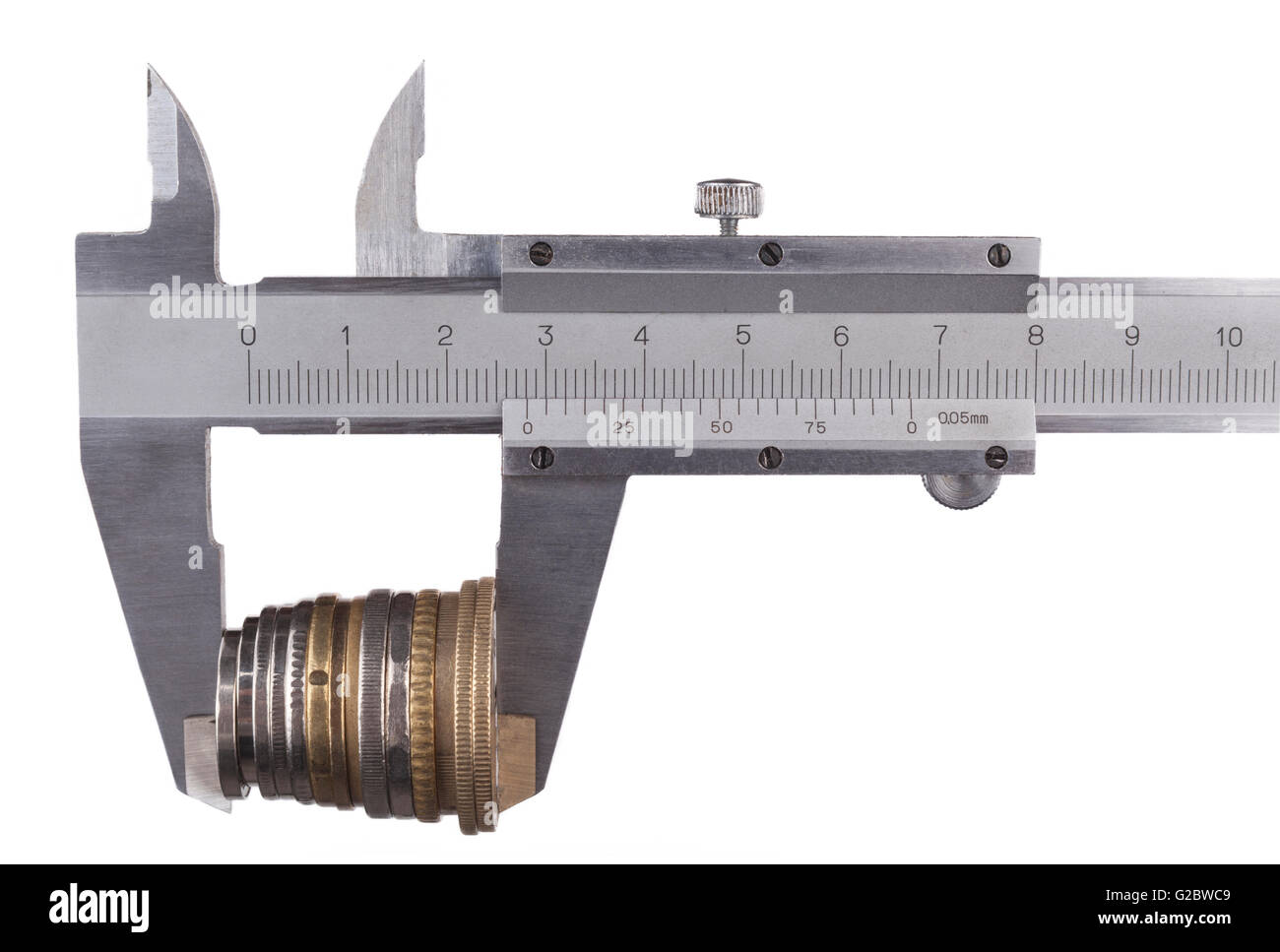 Measuring coins with silver tool isolated on white background Stock ...