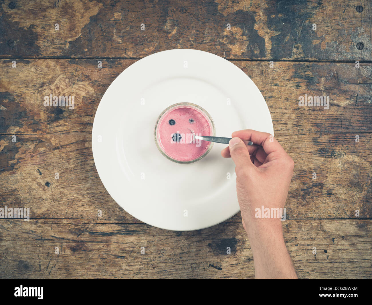 Overhead shot of a male hand scooping yogurt with a spoon Stock Photo ...