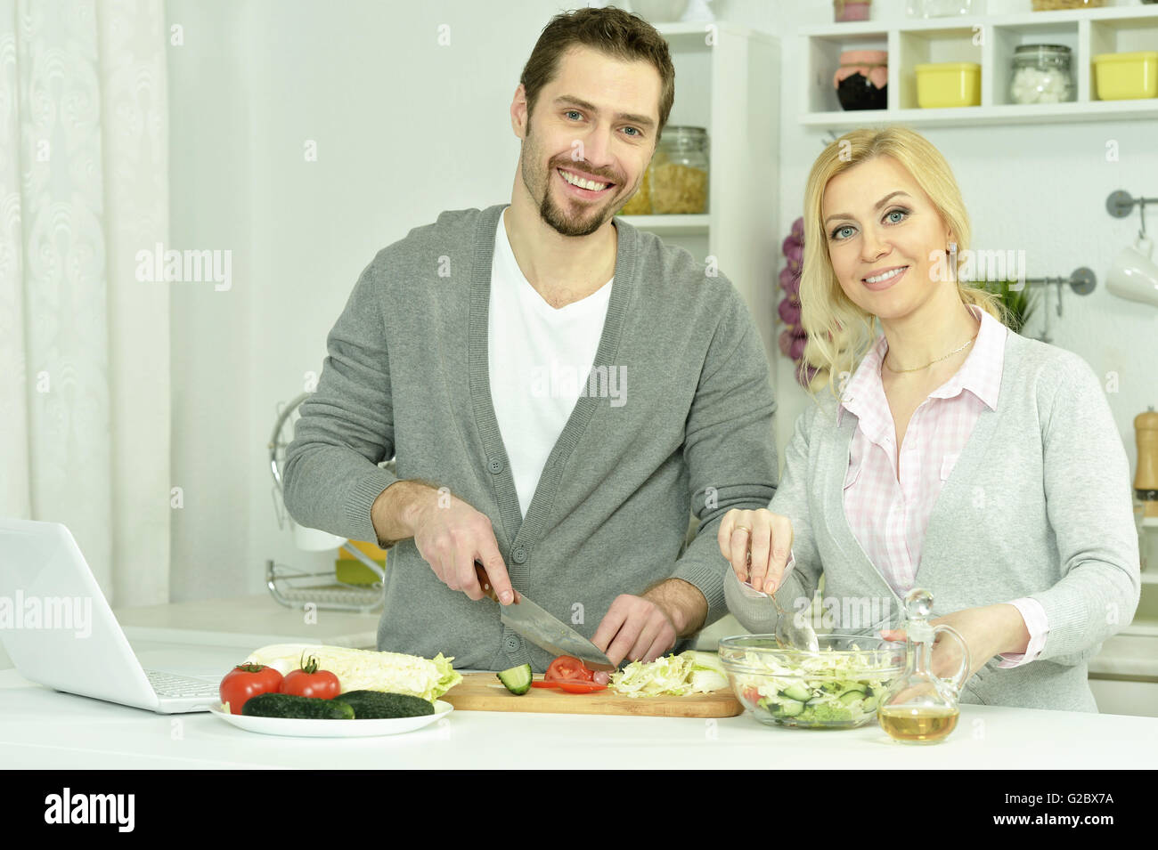 happy couple cooking in kitchen Stock Photo - Alamy