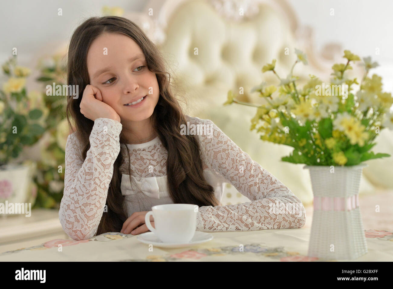 Little girl drinking tea Stock Photo - Alamy
