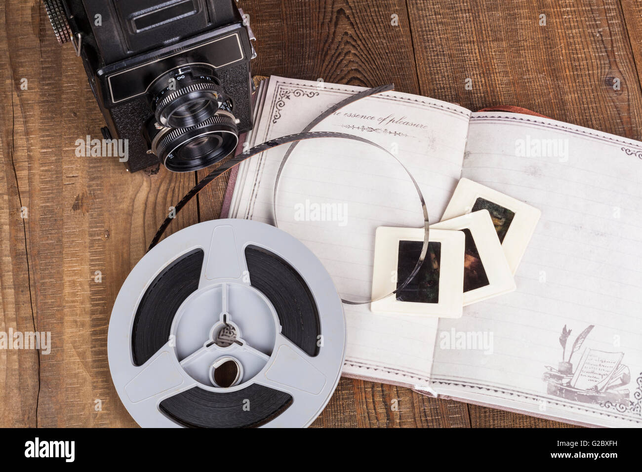 Old Camera Closeup on Brown Wood Background and a Film Roll Stock Photo ...
