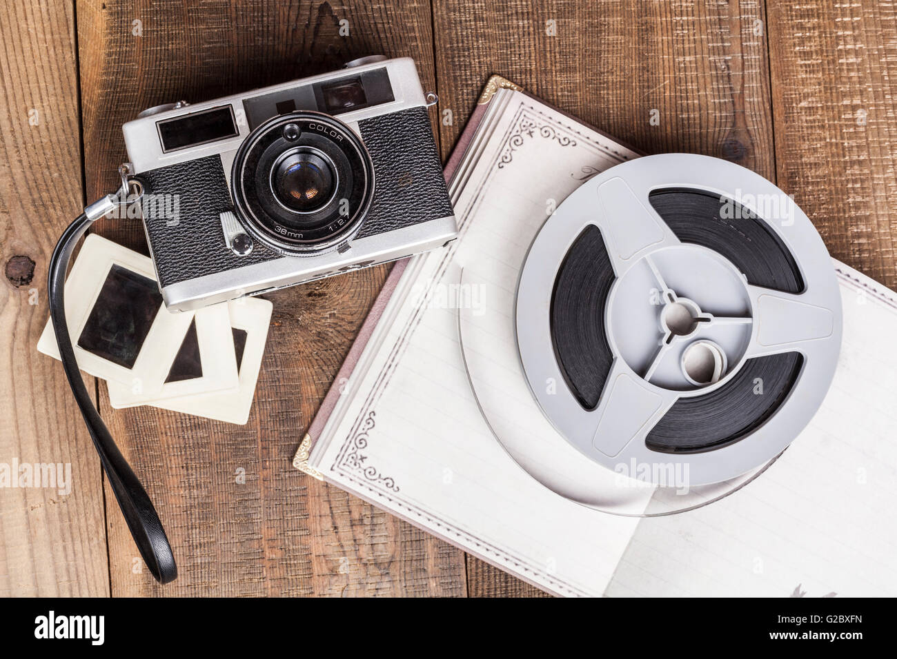 Old Camera Closeup on Brown Wood Background with open notepad and a ...