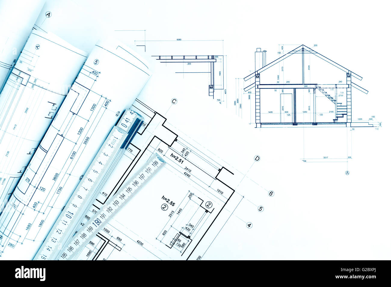 architects workspace, home plans and blueprint rolls with folding rule ...
