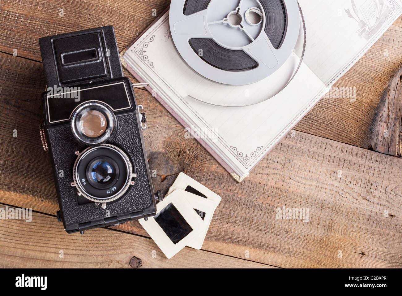Old Camera Closeup on Brown Wood Background and a Film Roll Stock Photo ...