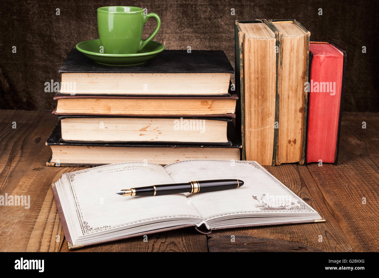 Old Books on Wood Table With Coffee and Open Notebook Stock Photo - Alamy