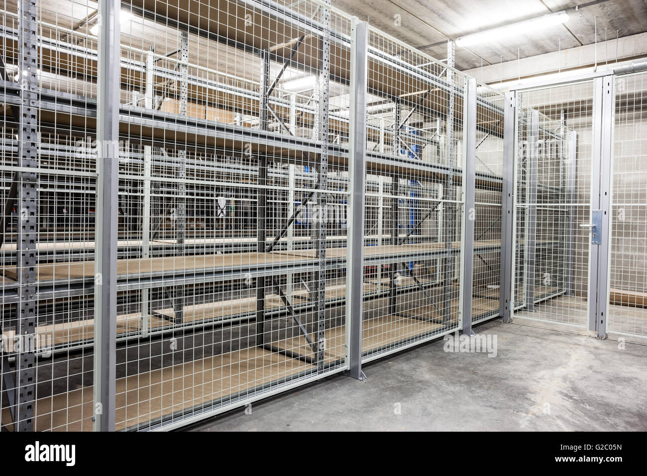 empty storage racks in a building with security Stock Photo - Alamy