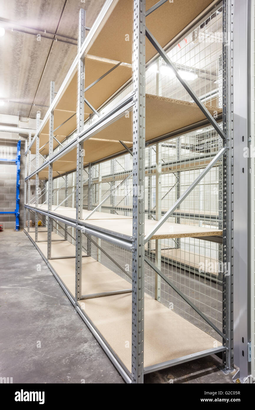 empty storage racks in a building with security Stock Photo - Alamy